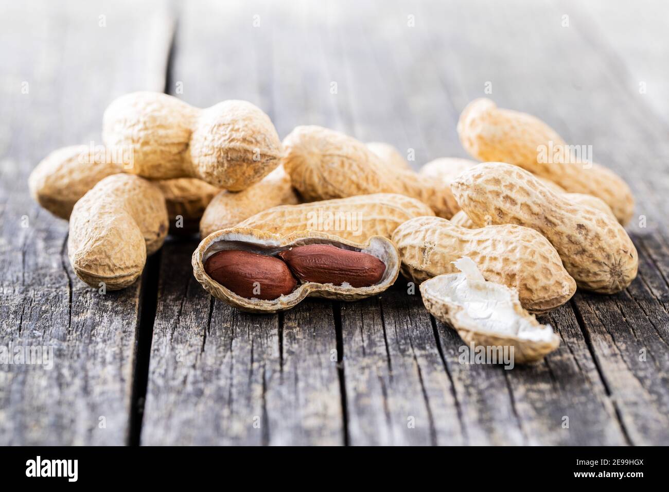 Roasted peanuts. Tasty groundnuts on wooden table Stock Photo - Alamy