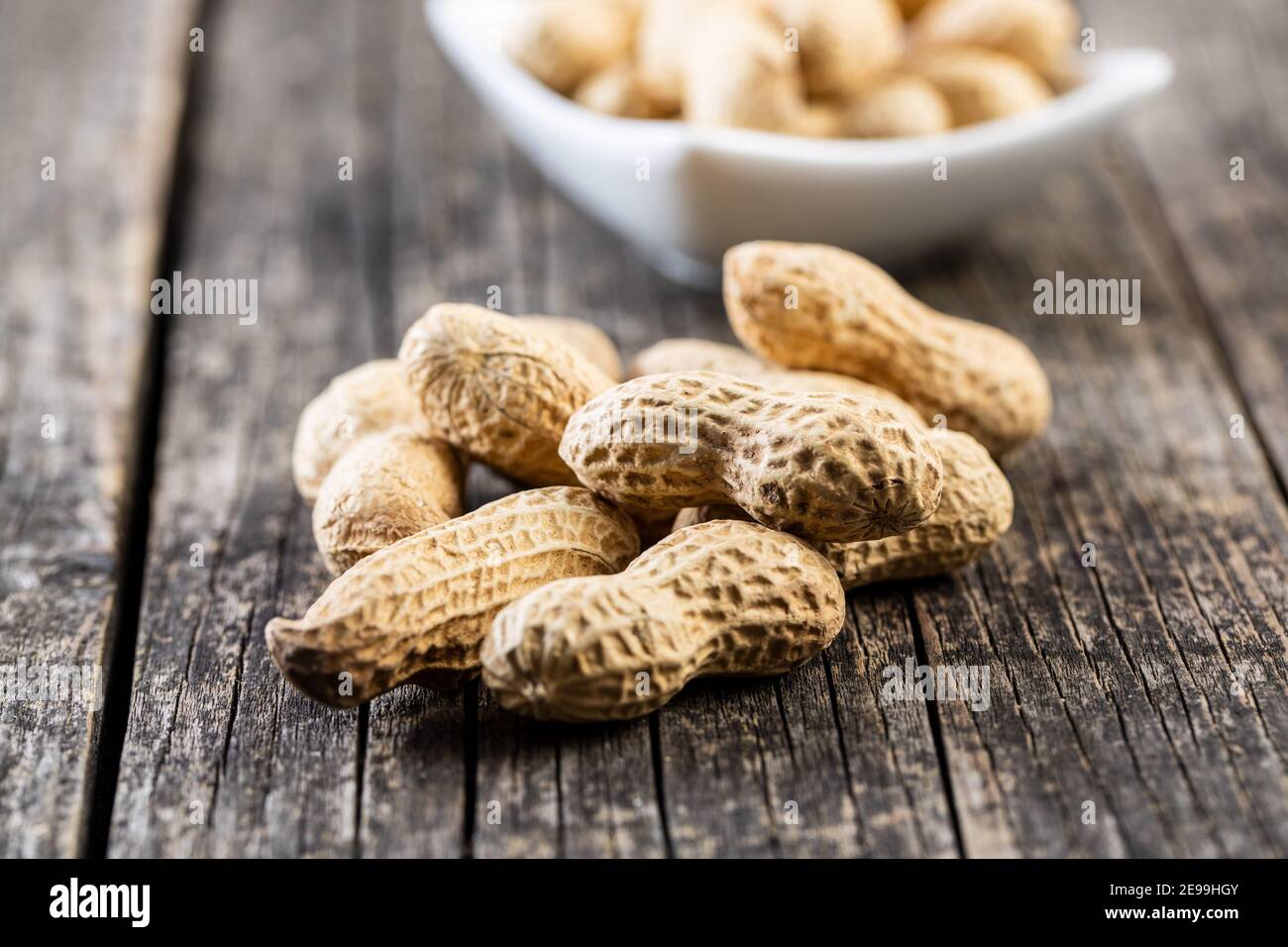 Roasted peanuts. Tasty groundnuts on wooden table Stock Photo - Alamy