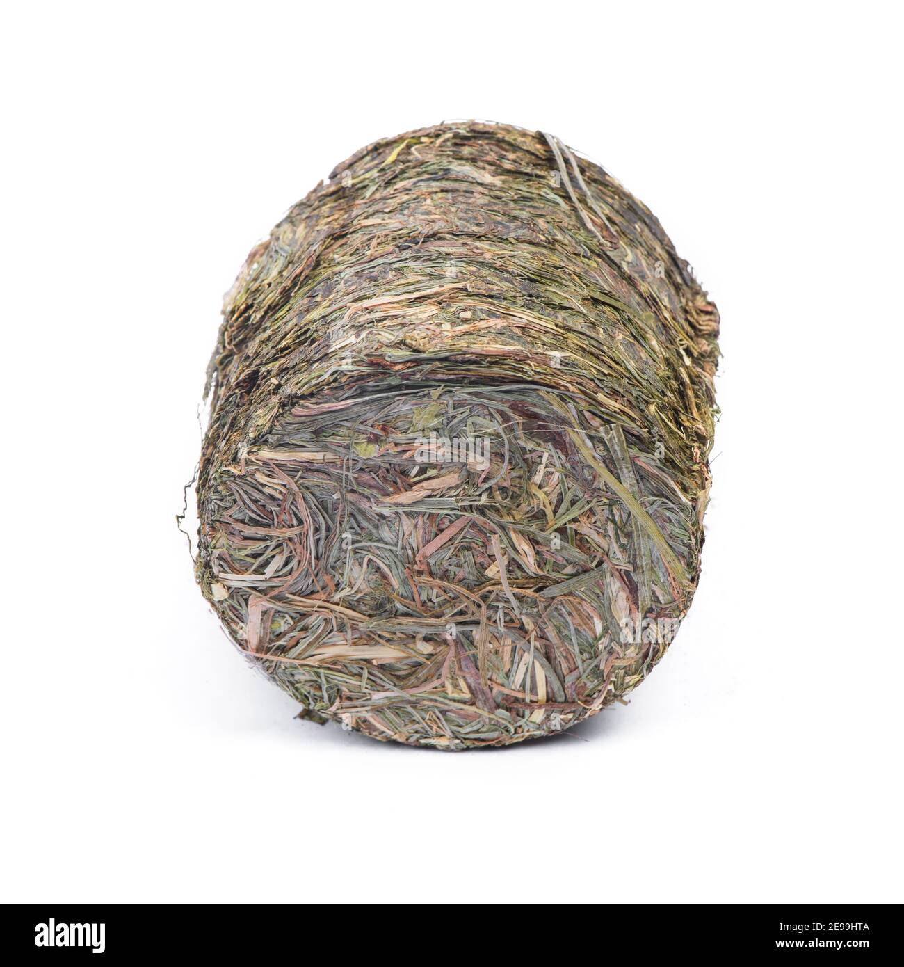 Pressed grass, hay in small cylinder isolated over white background ...