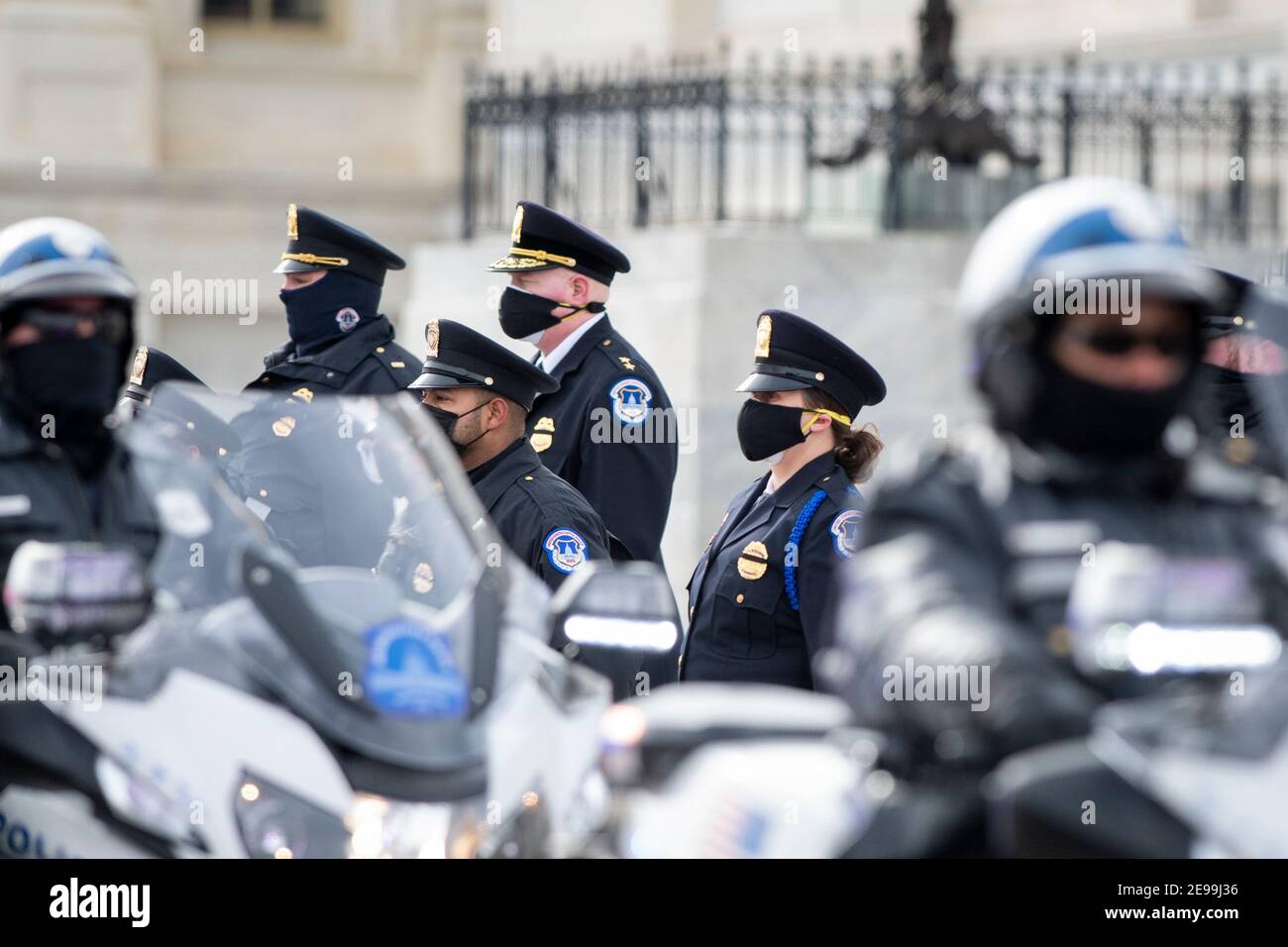 U.S. Capitol Police salute as a hearse carrying an urn with the ...
