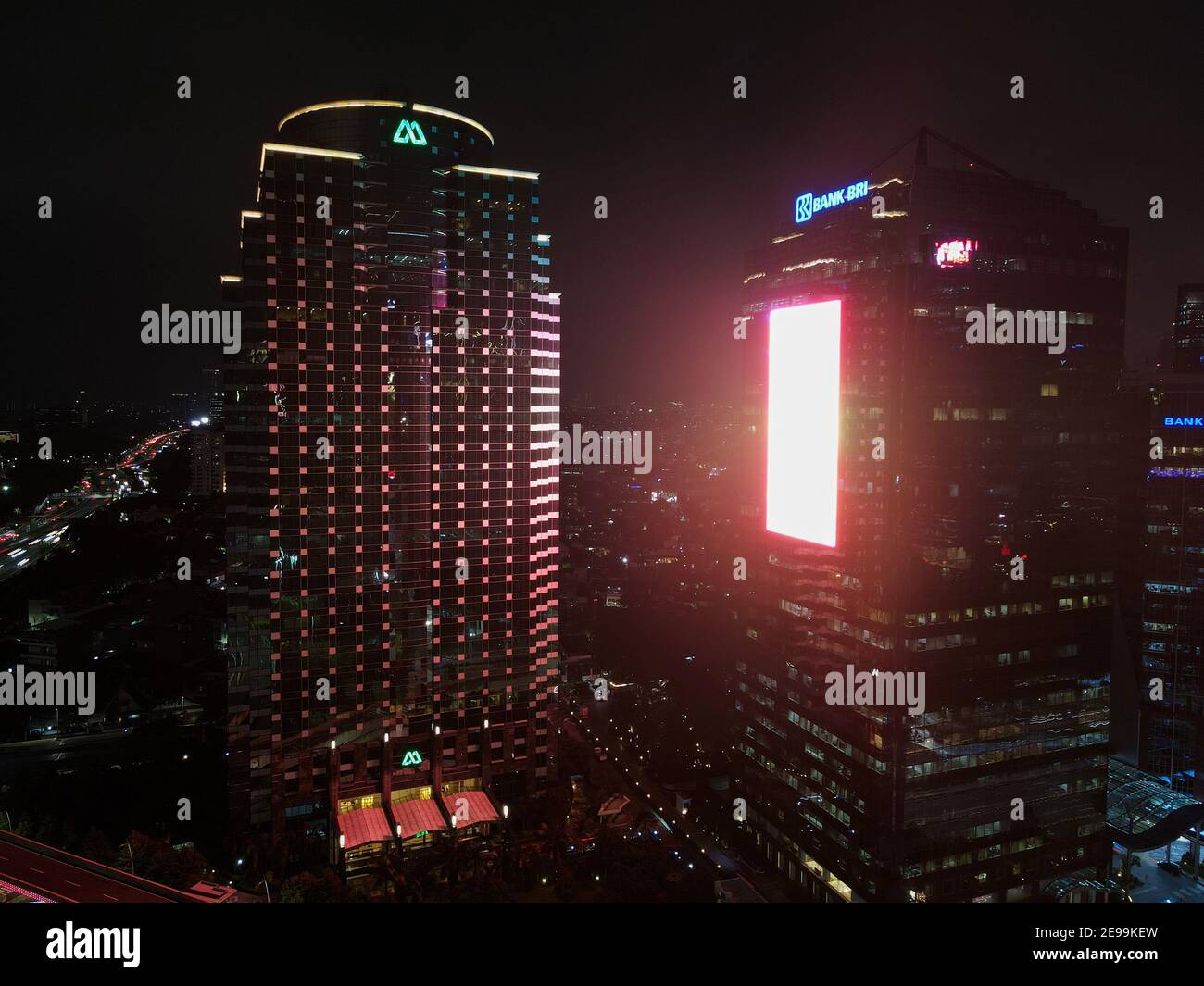 Spectacular nighttime skyline of a big modern city at night. Semanggi ...