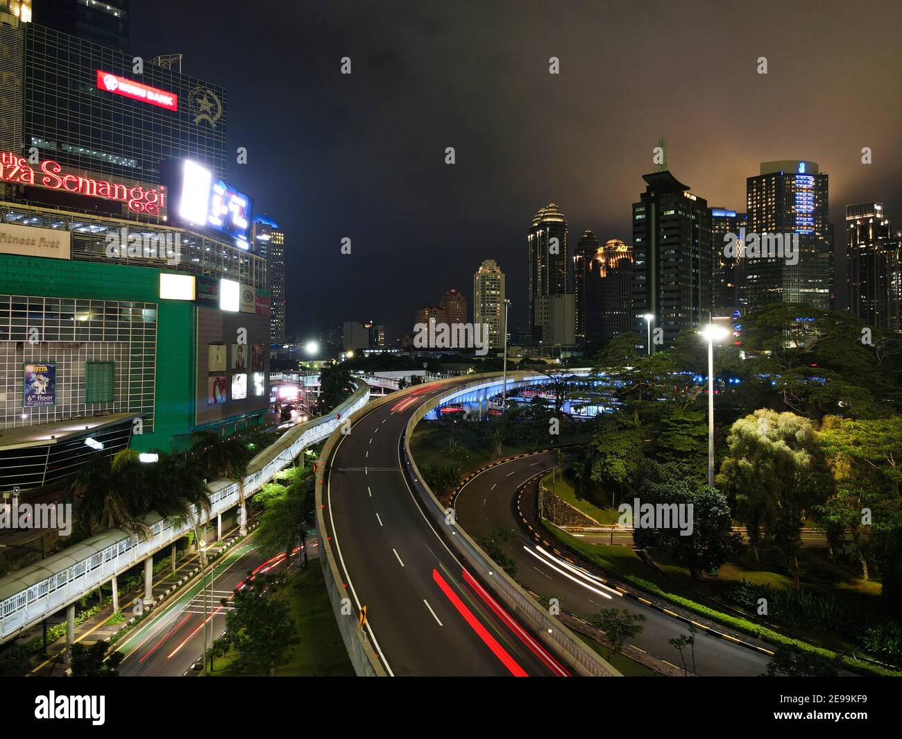 Spectacular nighttime skyline of a big modern city at night. Semanggi ...