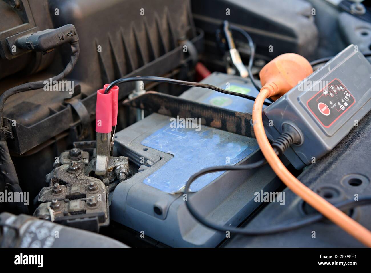 charging the car battery with a small charger Stock Photo - Alamy