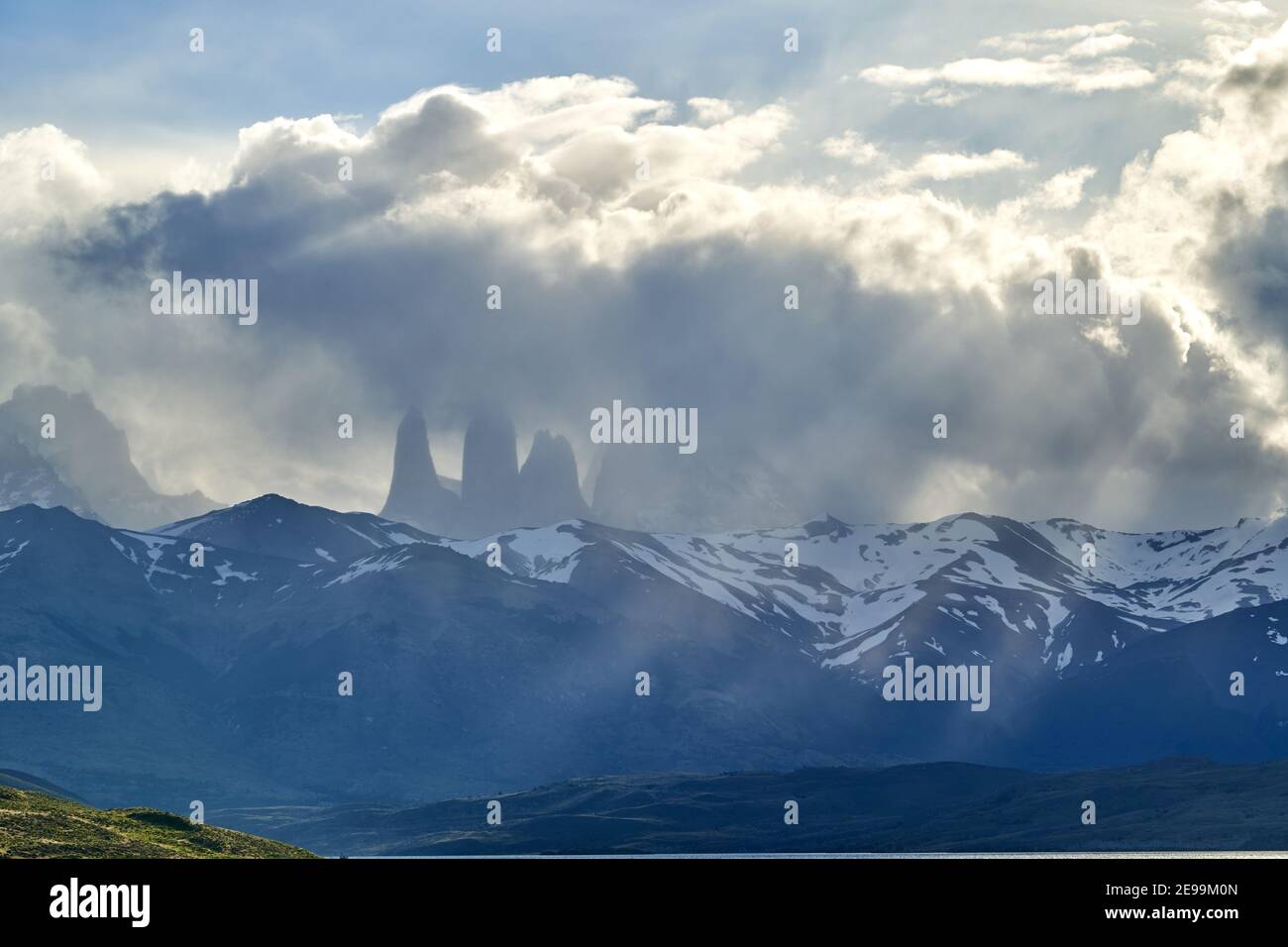 Towers of torres del Paine national park covered in clouds with dark ...