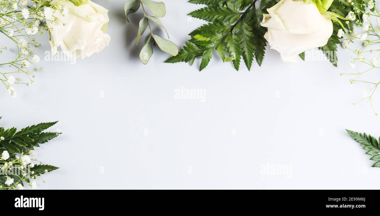 Floral arrangement frame with white roses and fern Stock Photo - Alamy