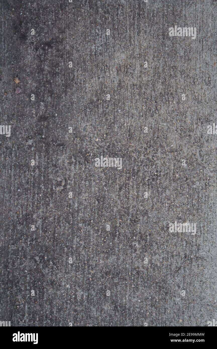 Direct overhead shot of the rough texture of light gray concrete with ...