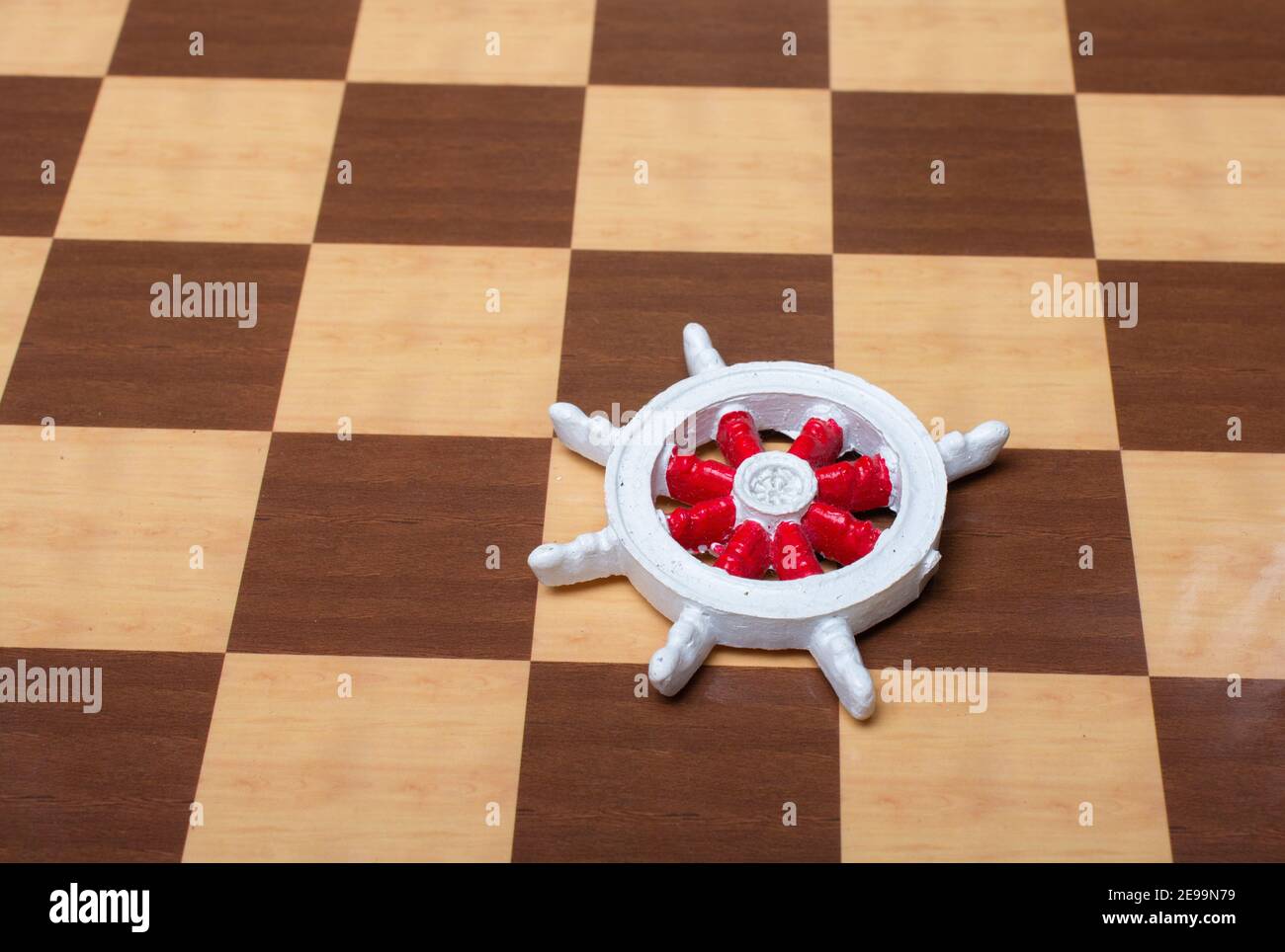 Closeup of the white painted small boat helm on the wooden chessboard ...