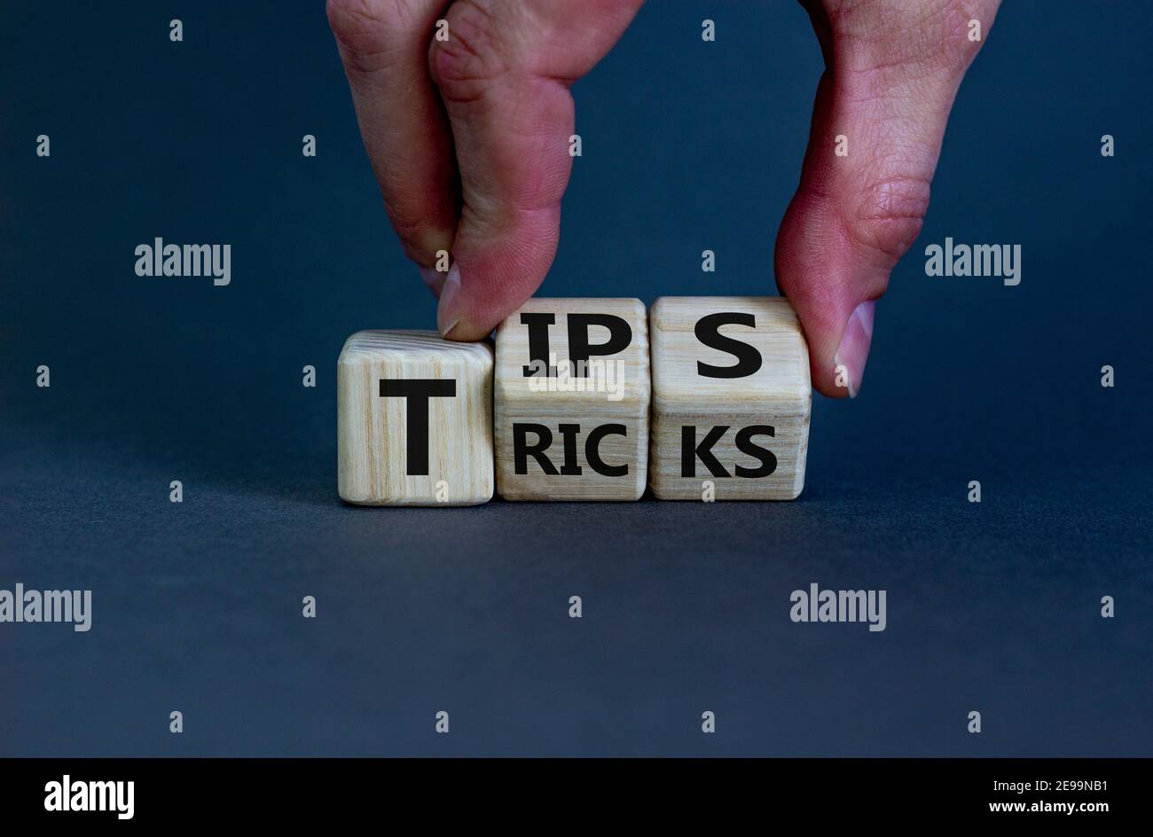 Tips and tricks symbol. Businessman turns cubes and changes the word ...