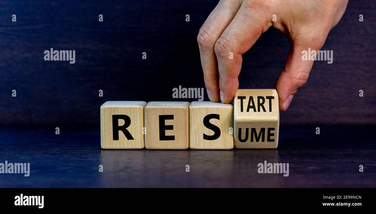 Resume and restart symbol. Businessman hand turns cubes and changes the ...