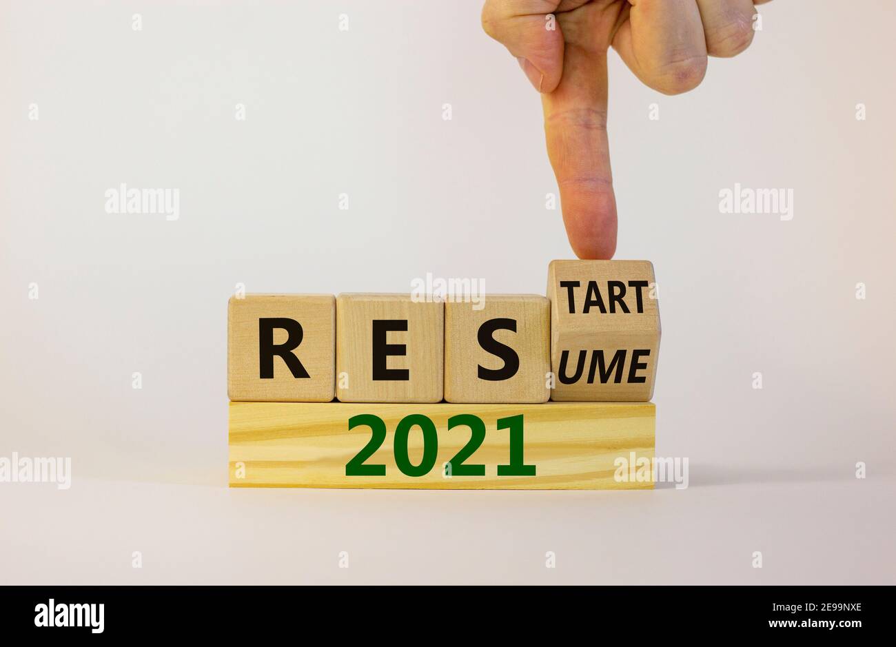 2021 resume and restart symbol. Businessman turns a cube and changes ...