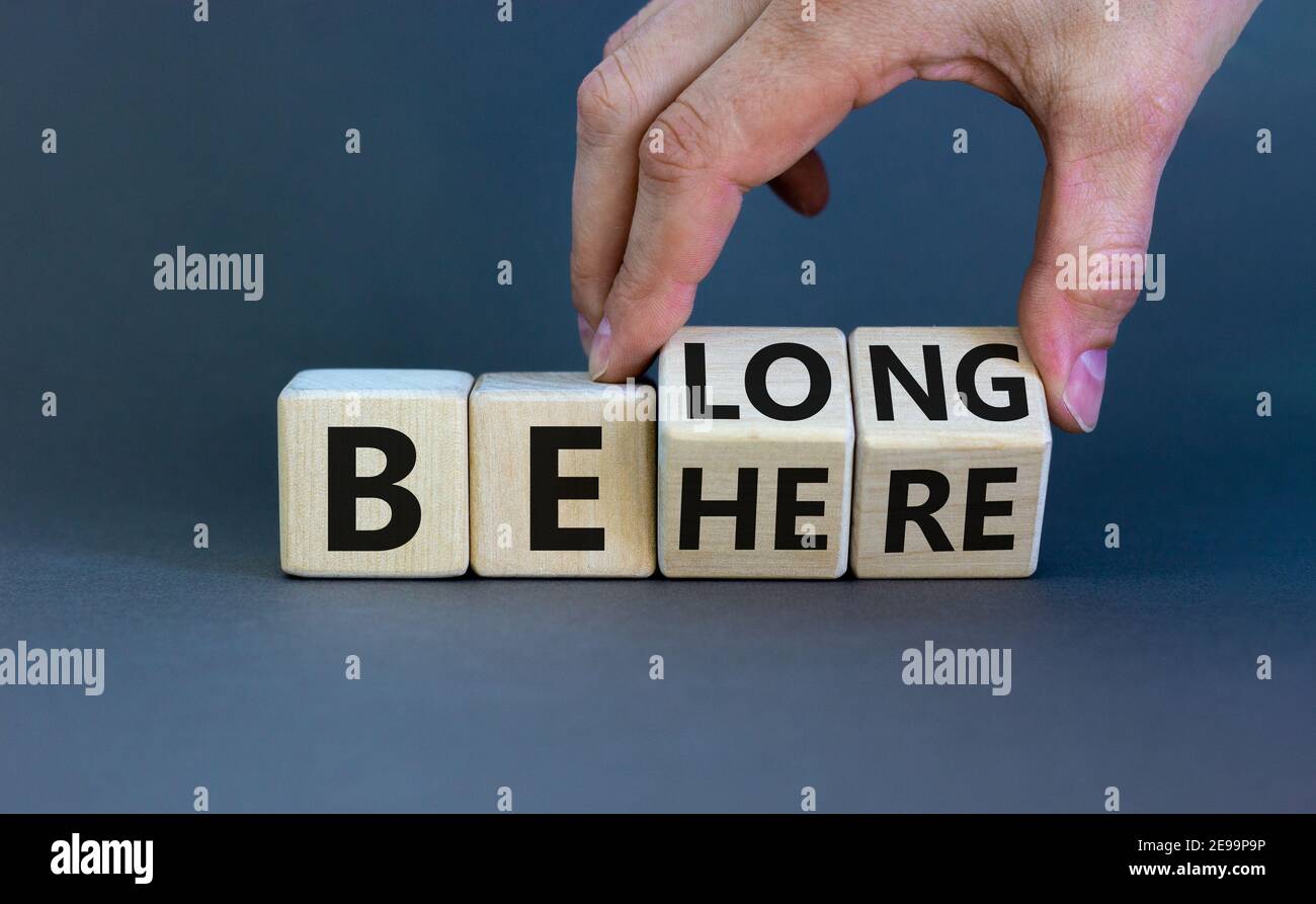 Be here belong symbol. Businessman hand turns cubes and changes words ...