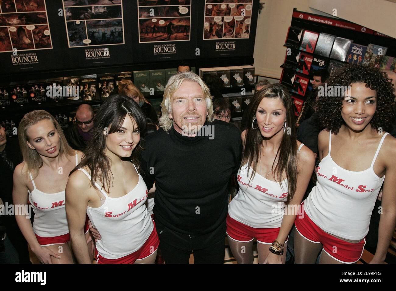 Sir Richard Branson poses with models during a photocall to launch the ...