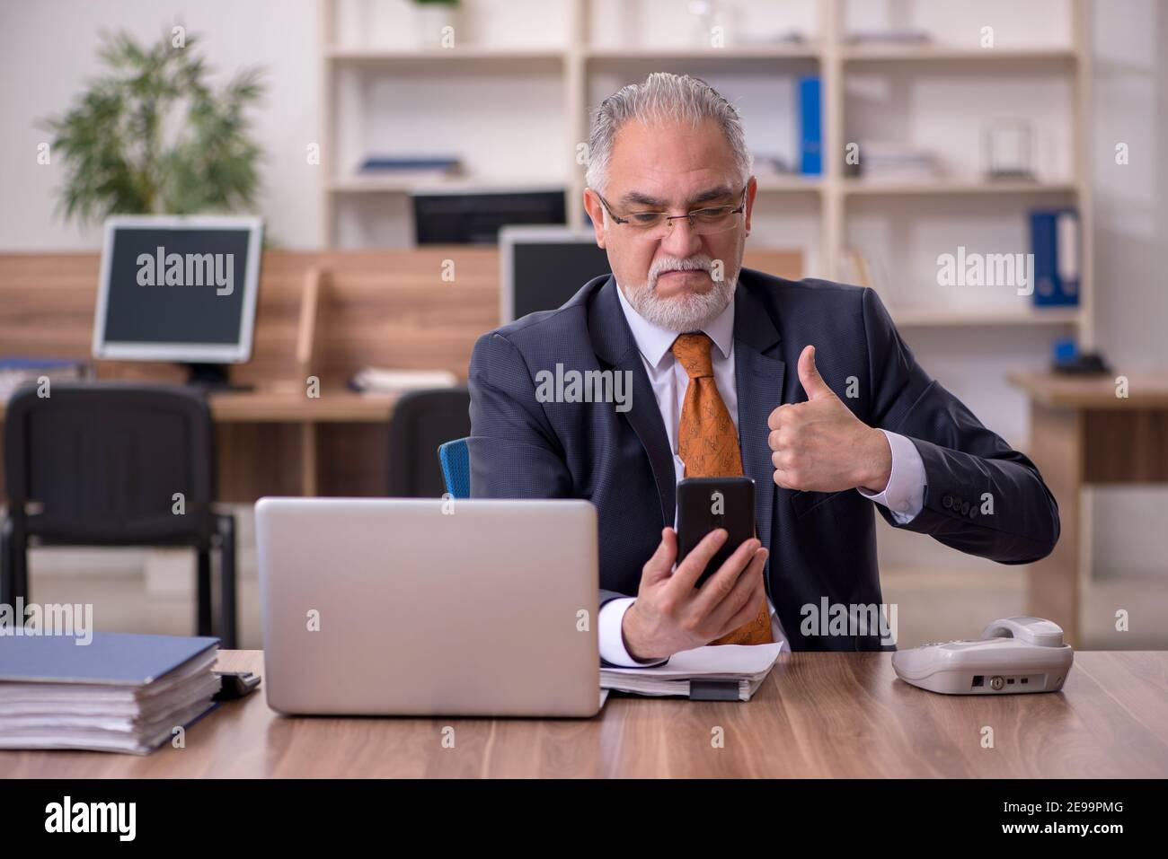 Old employee working in the office Stock Photo - Alamy