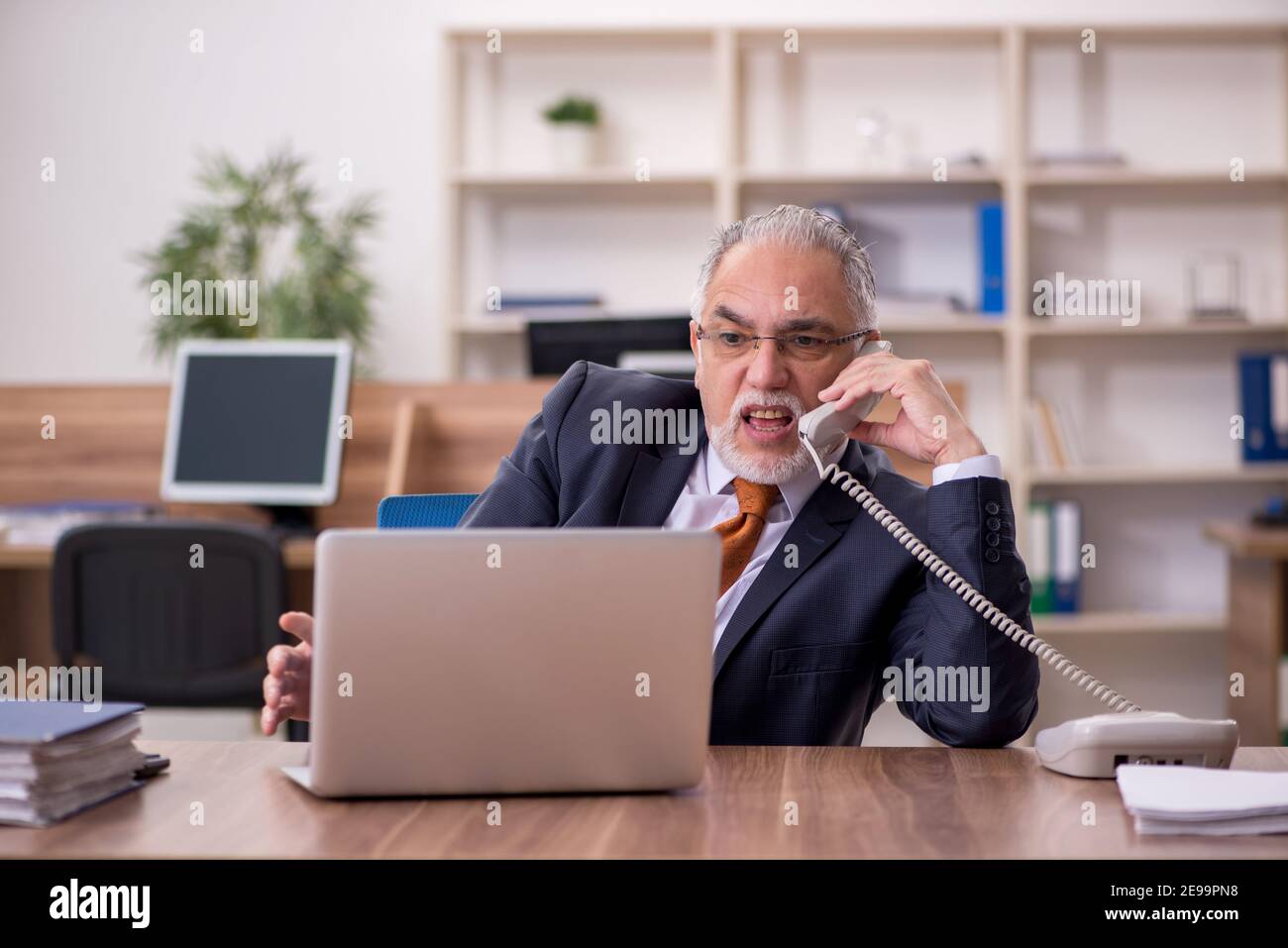 Old employee working in the office Stock Photo - Alamy