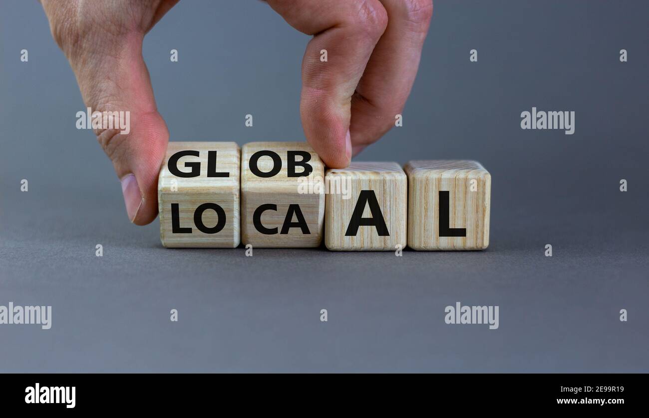 Local or global symbol. Hand turns cubes and changes the word 'local ...