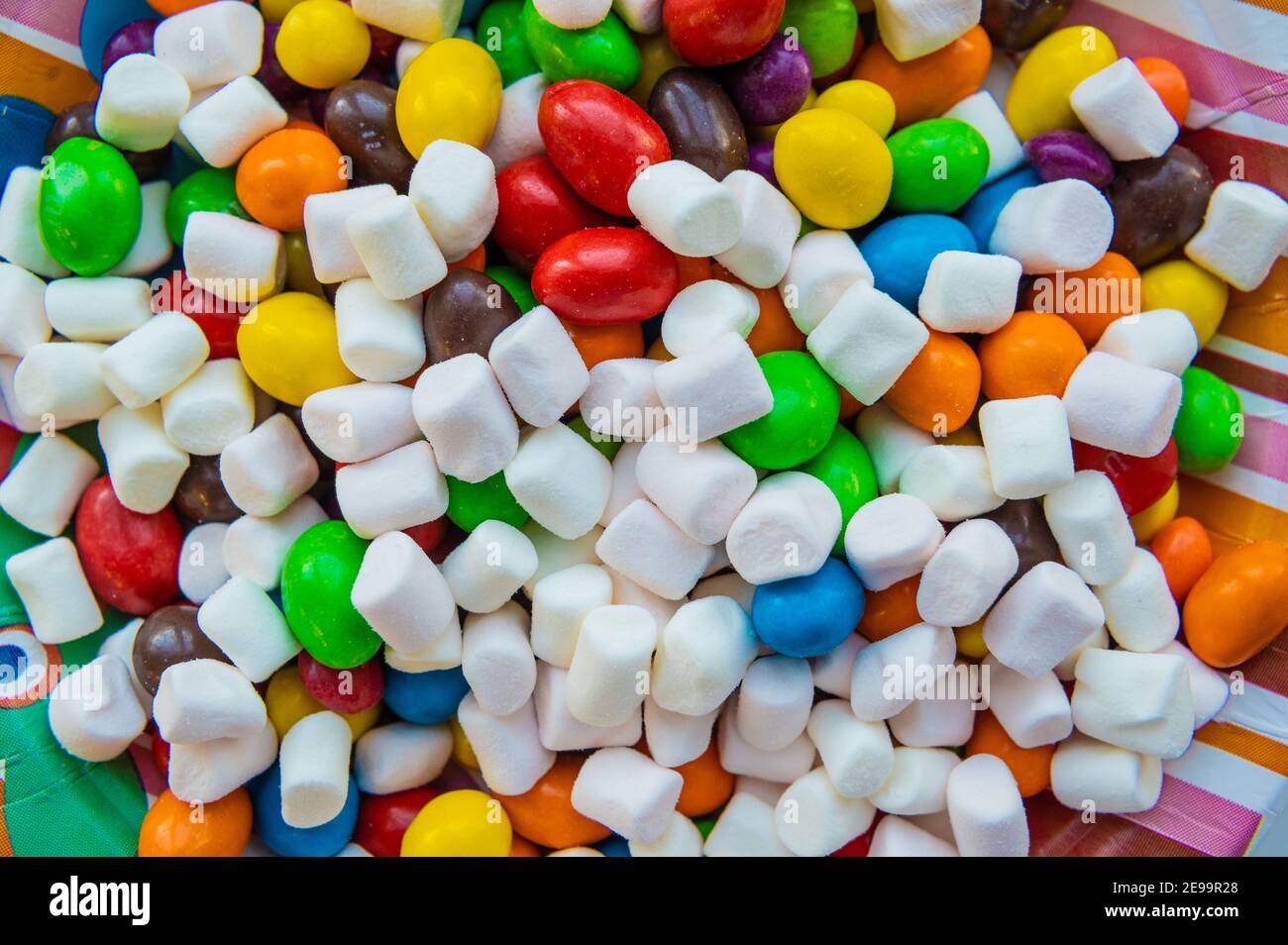 Mixed marshmallow candies with sugar, banana jelly candies, background ...
