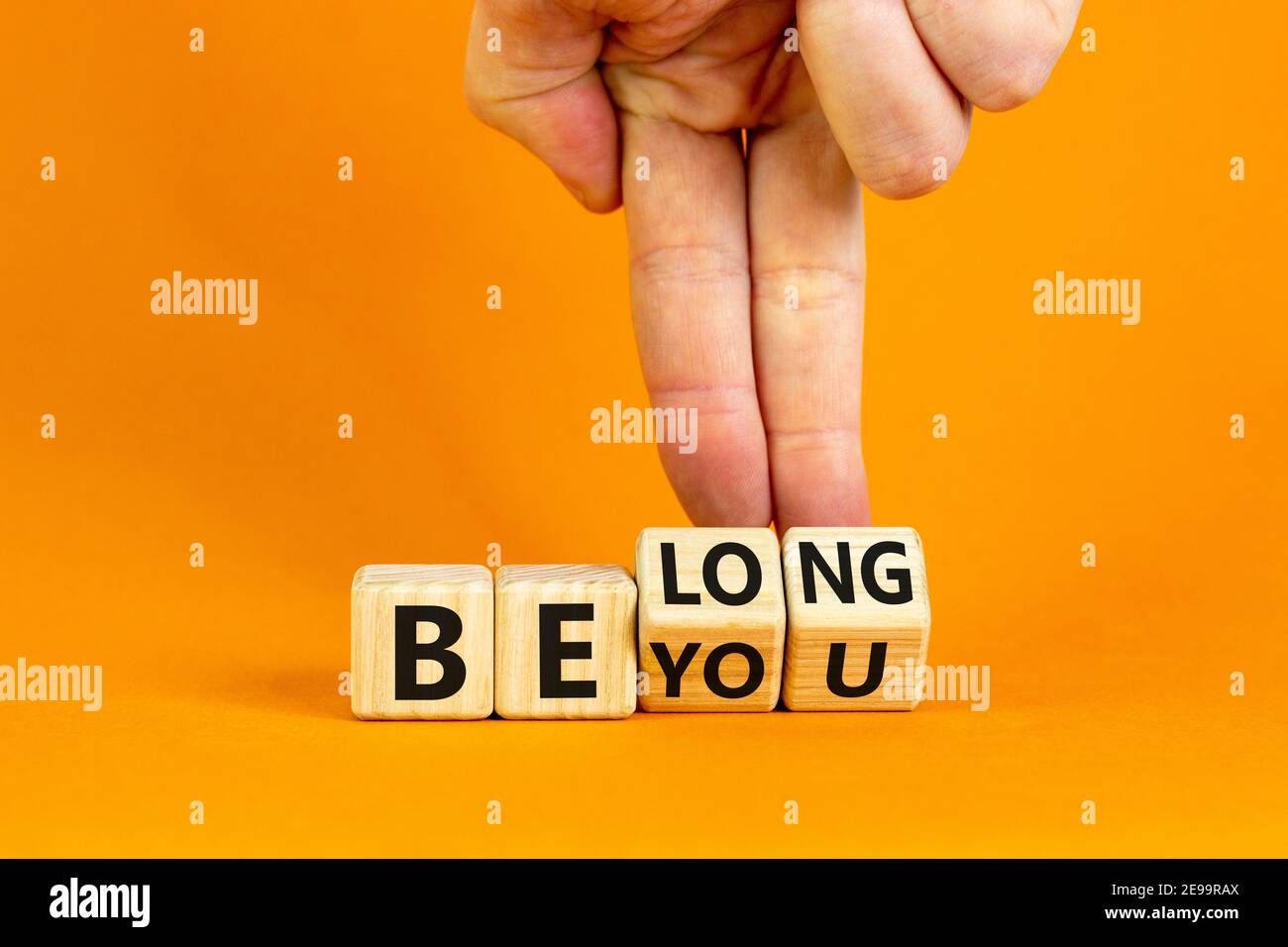 Be you, belong symbol. Businessman hand turns cubes and changes words ...