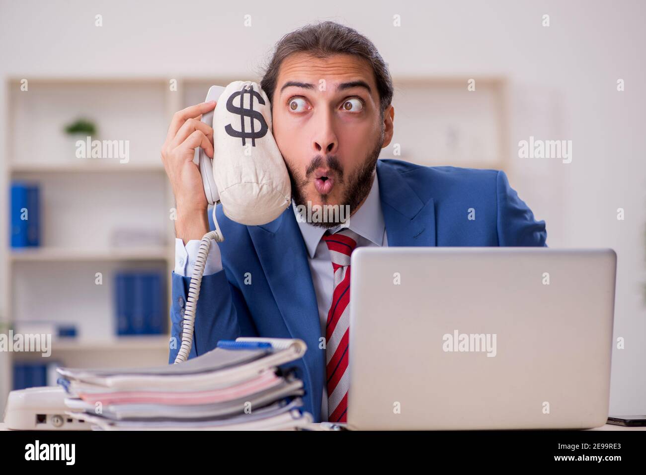 Young employee in remuneration concept Stock Photo - Alamy