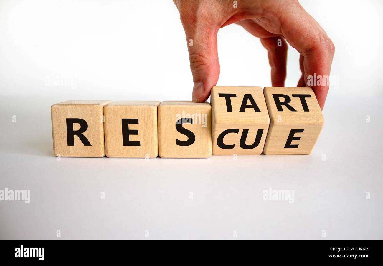 Rescue and restart symbol. Businessman hand turns cubes and changes the ...