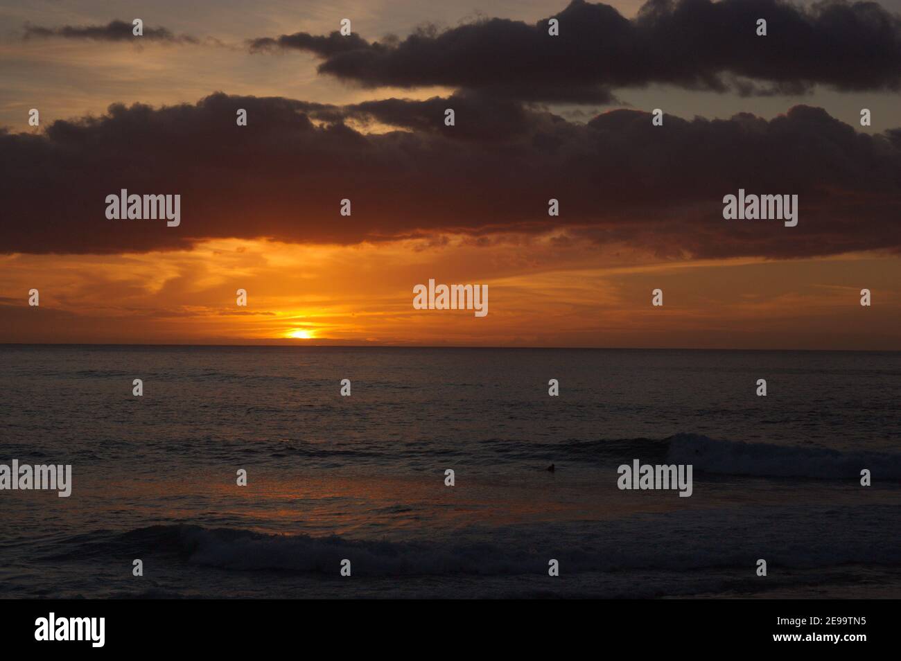 Landscape in which we see the sun falling on the sea with waves and ...