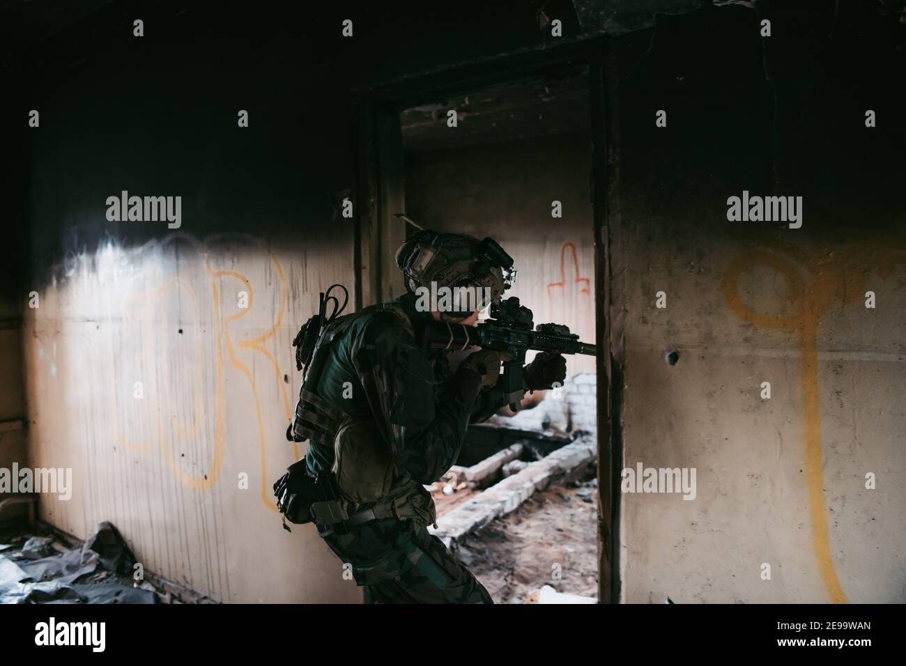 Soldier in combat. Urban combat training, soldier entering abandoned ...
