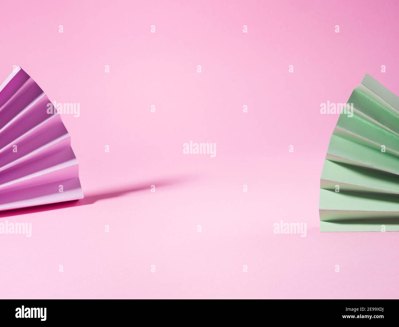 Geometrical pink background with paper colorful fans Stock Photo - Alamy