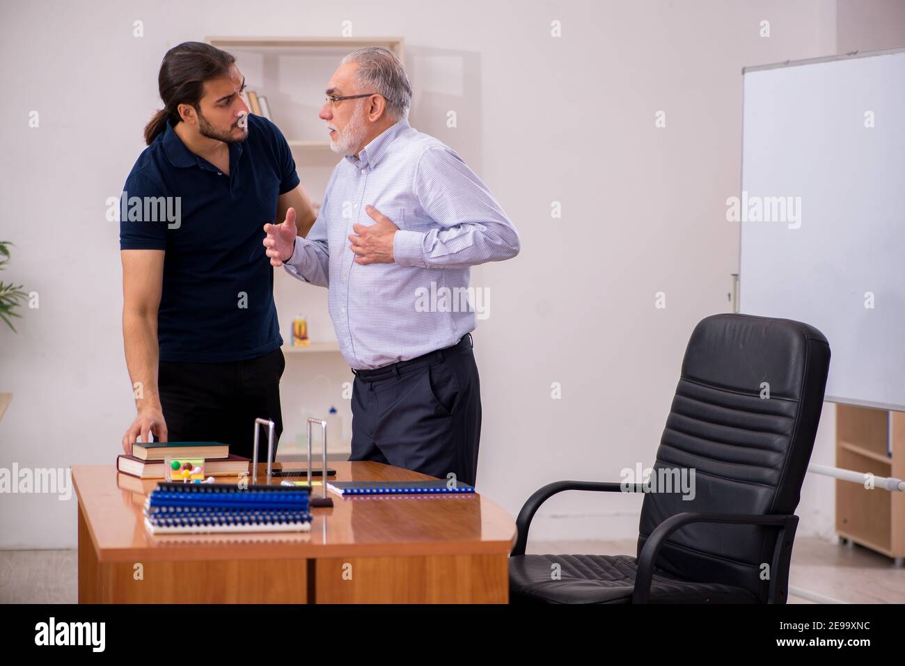 Aged male teacher feeling bad during individual lesson Stock Photo - Alamy