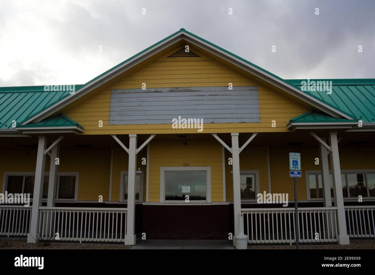 An empty restaurant stands vacant in front of an overcast sky in the ...