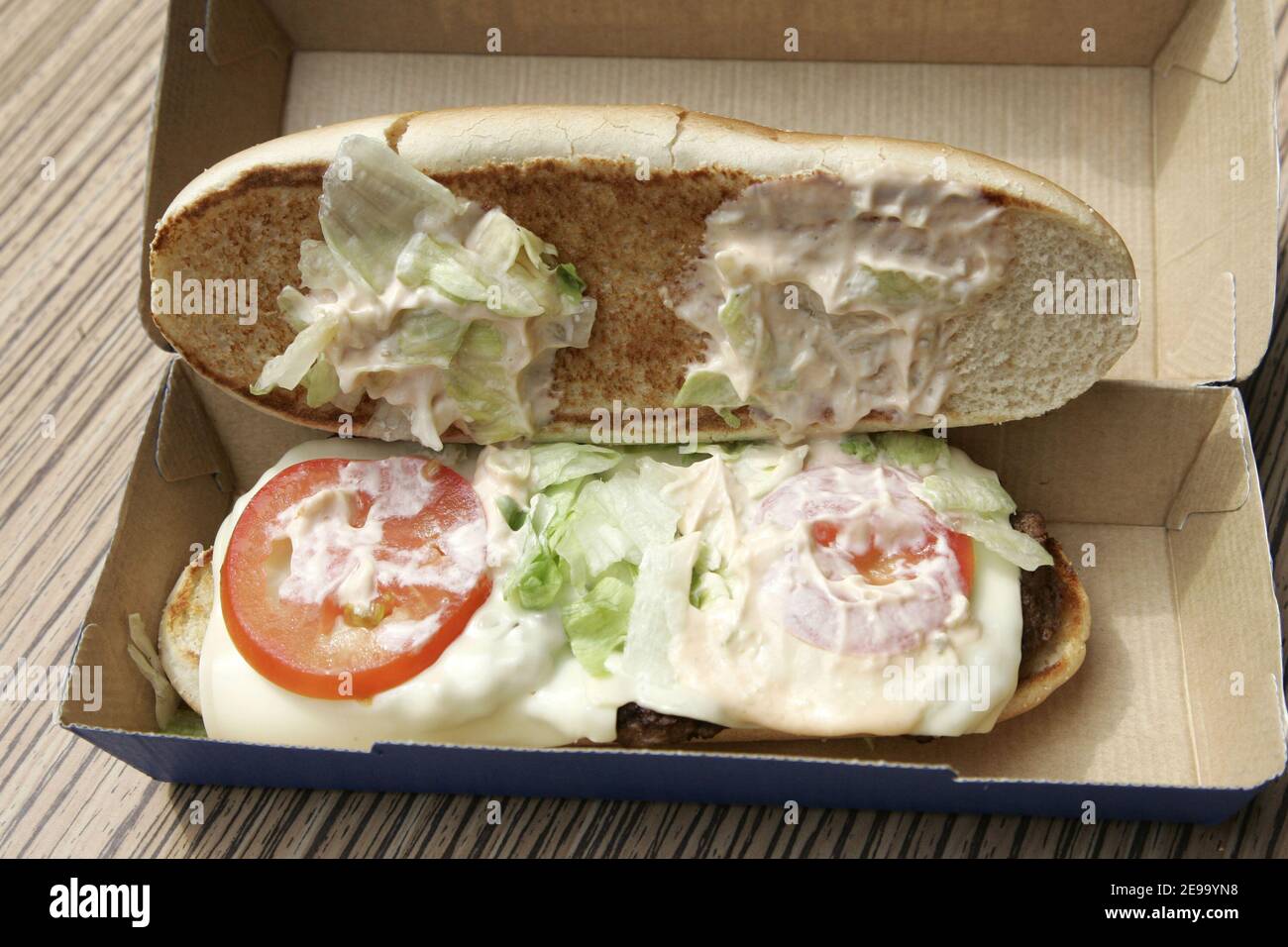 A young lady eats the new 'Cauet Burger' ( named after French TV anchor ...