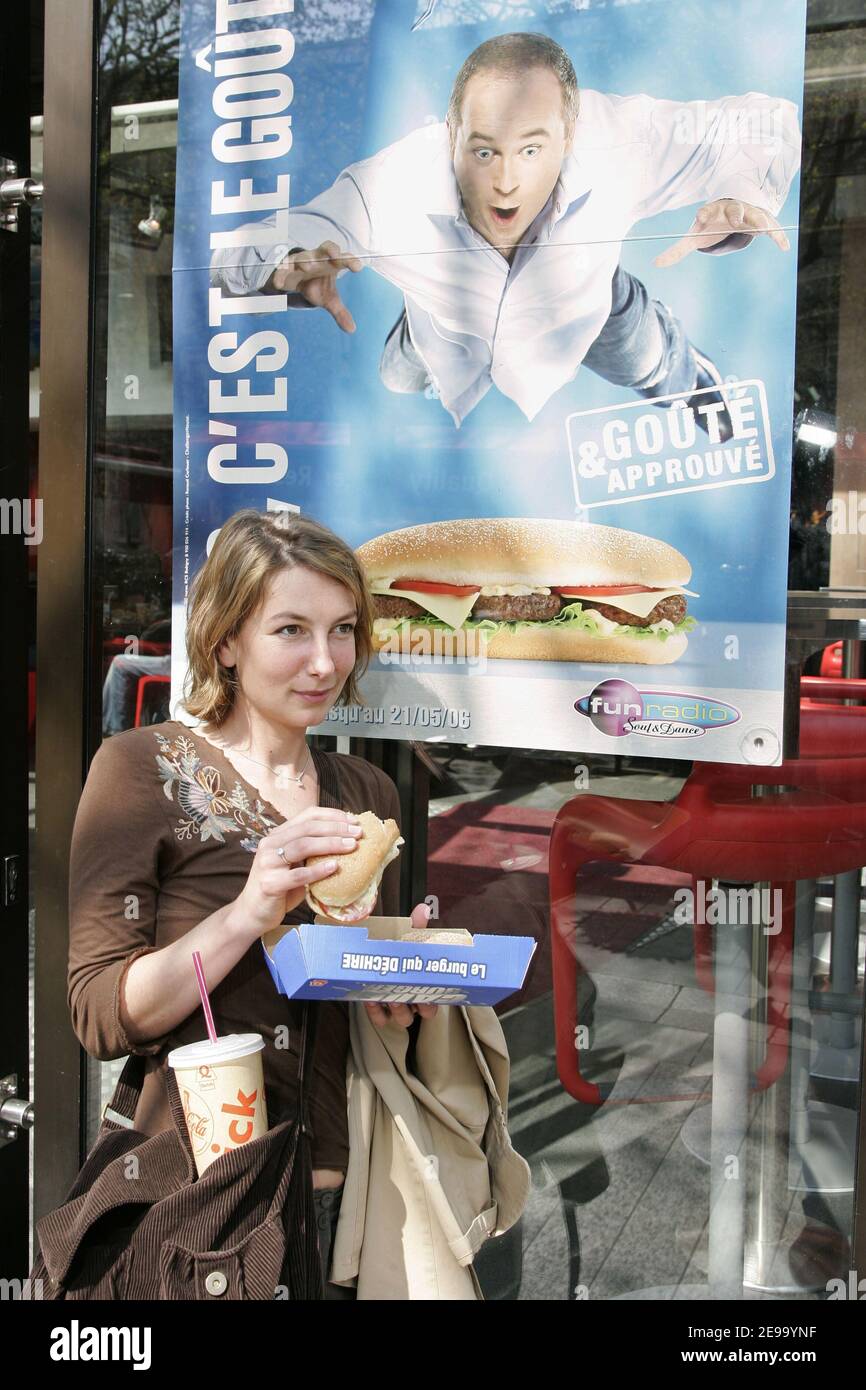 A young lady enjoys the new 'Cauet Burger' (named after French TV ...