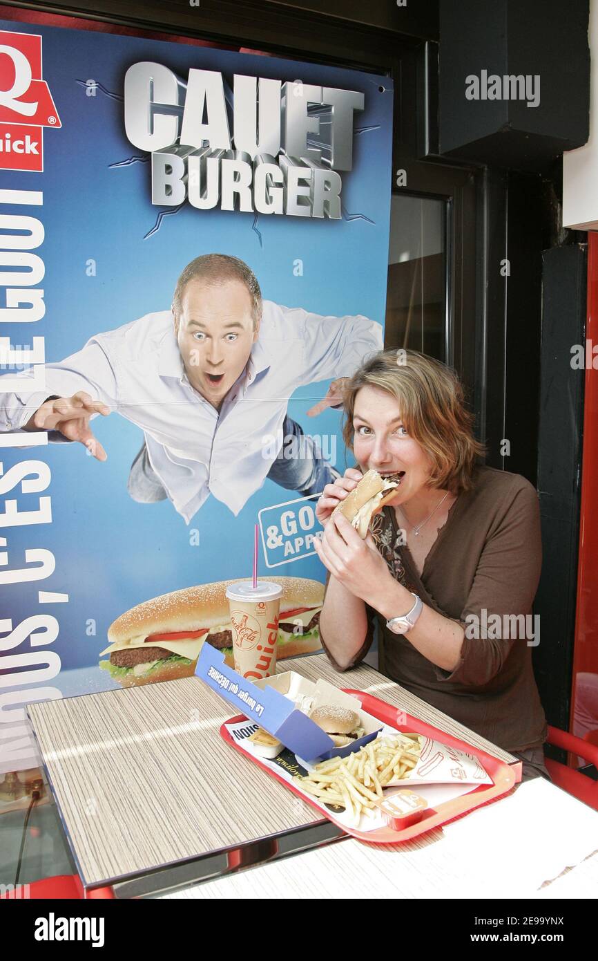 A young lady enjoys the new 'Cauet Burger' (named after French TV ...