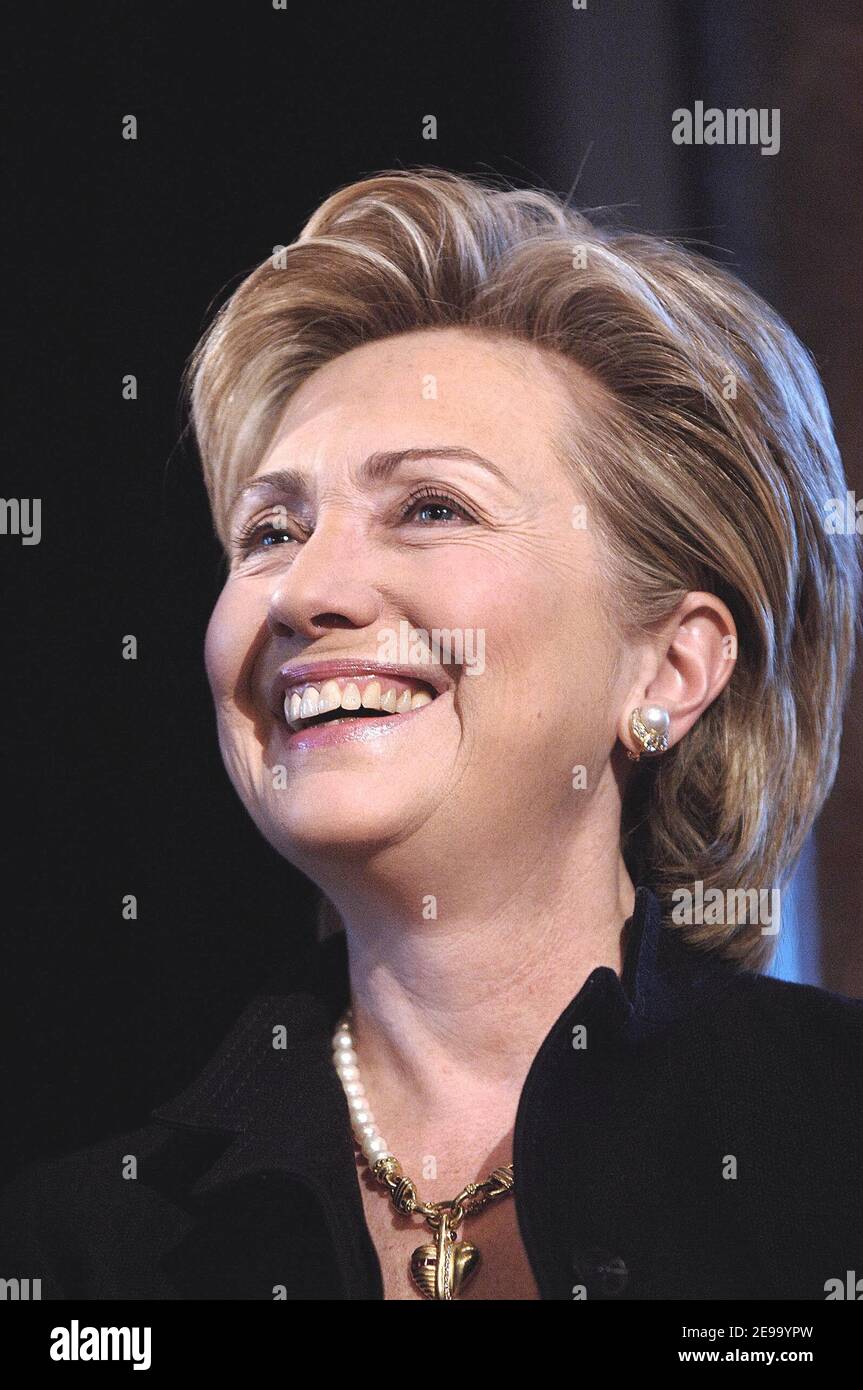U.S. Senator Hillary Clinton (D-NY) stands near her portrait during an ...