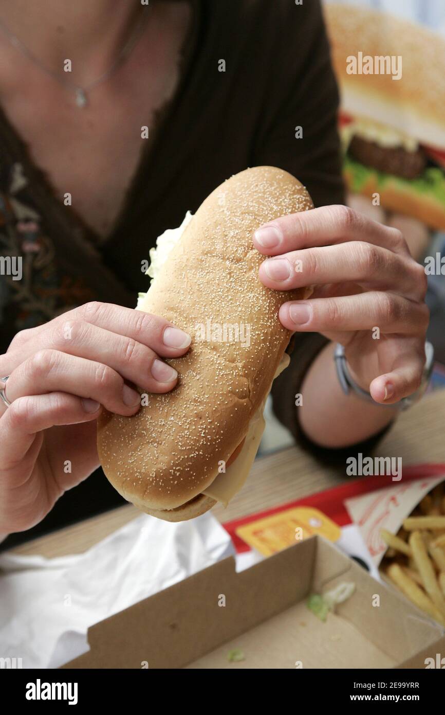 A young lady enjoys the new 'Cauet Burger' (named after French TV ...