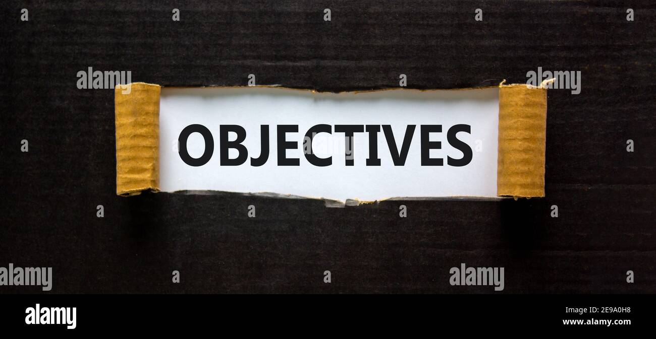 Objectives symbol. The word 'objectives' appearing behind torn black ...