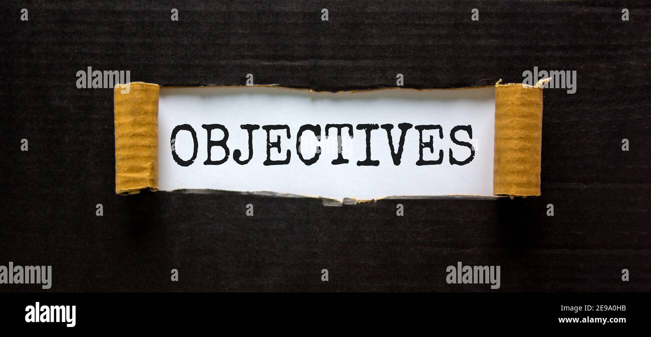Objectives symbol. The word 'objectives' appearing behind torn black ...