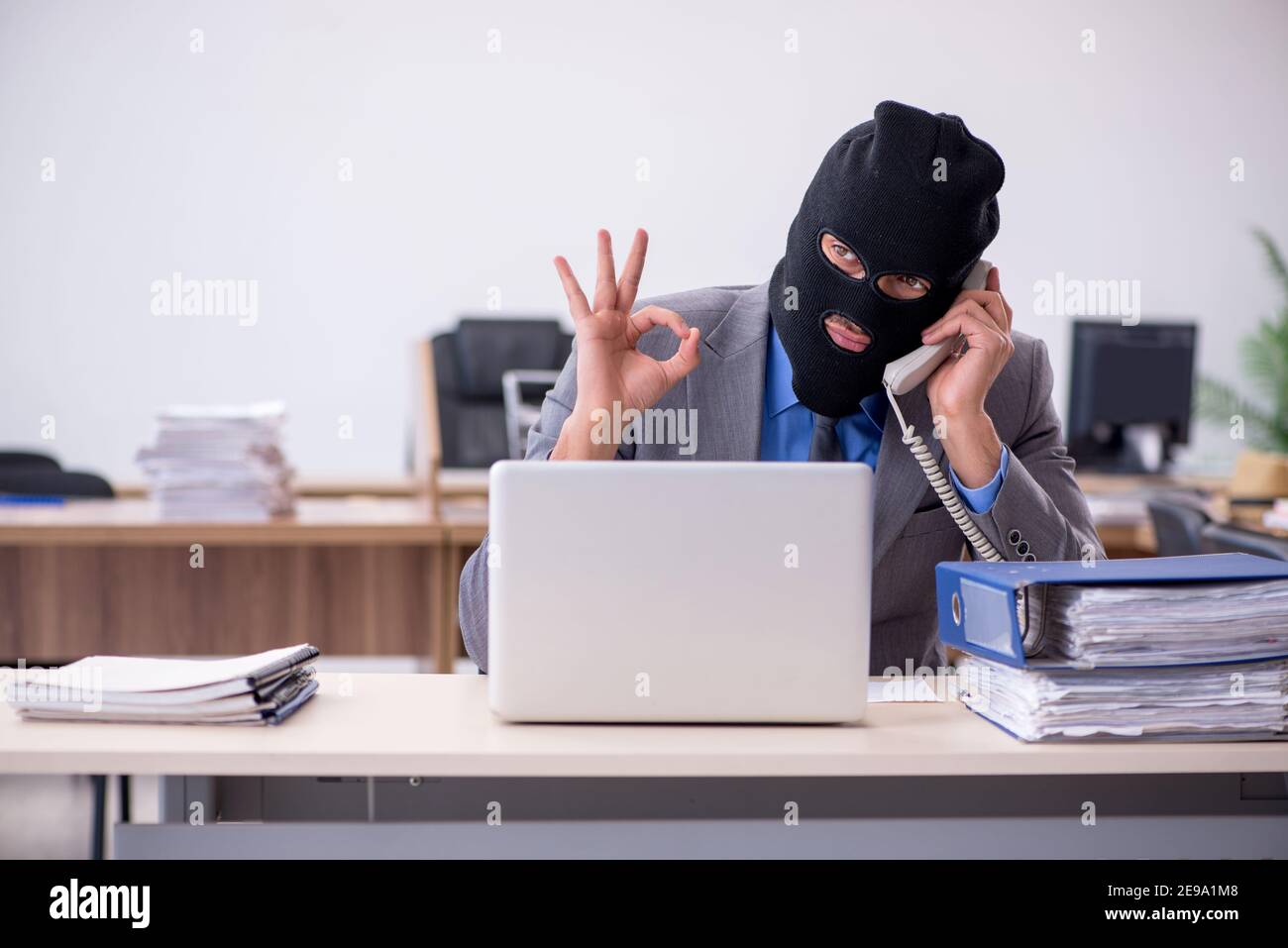 Young employee in industrial espionage concept Stock Photo - Alamy