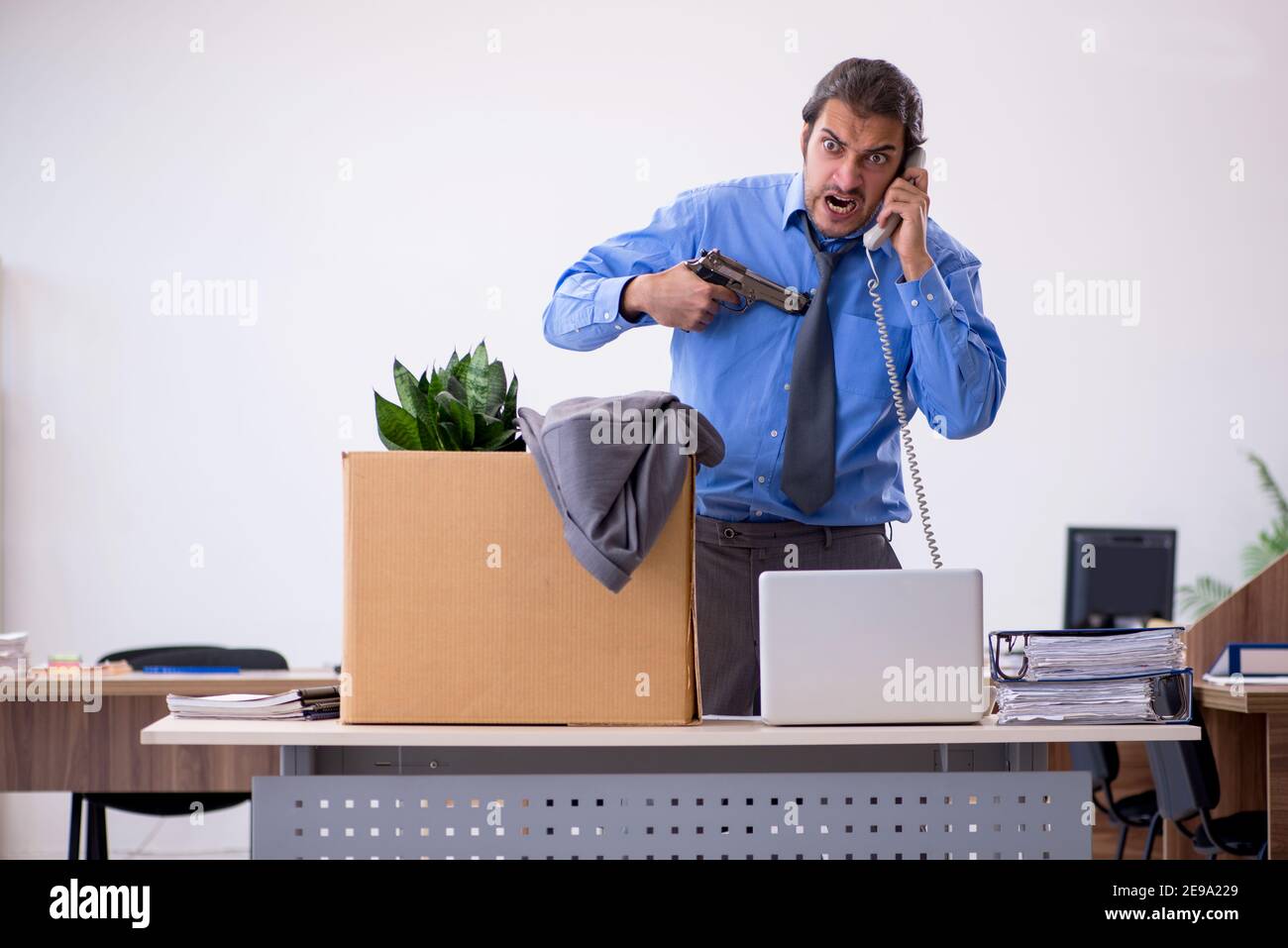 Young employee being fired from his work Stock Photo - Alamy