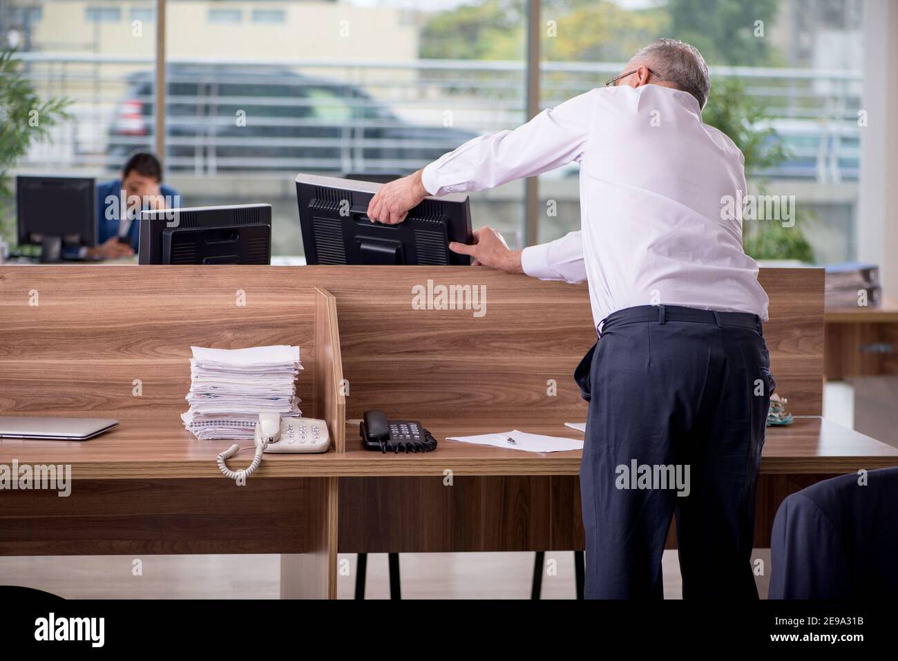 Two businessmen employees sitting in the office Stock Photo - Alamy