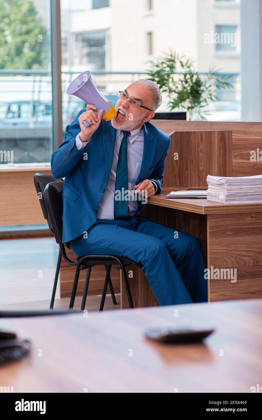 Old employee working in the office Stock Photo - Alamy