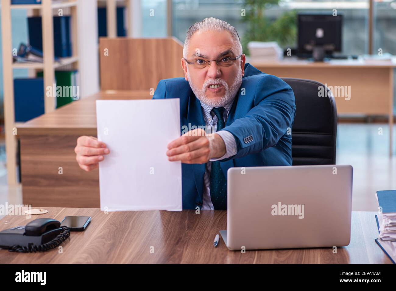 Old employee working in the office Stock Photo - Alamy
