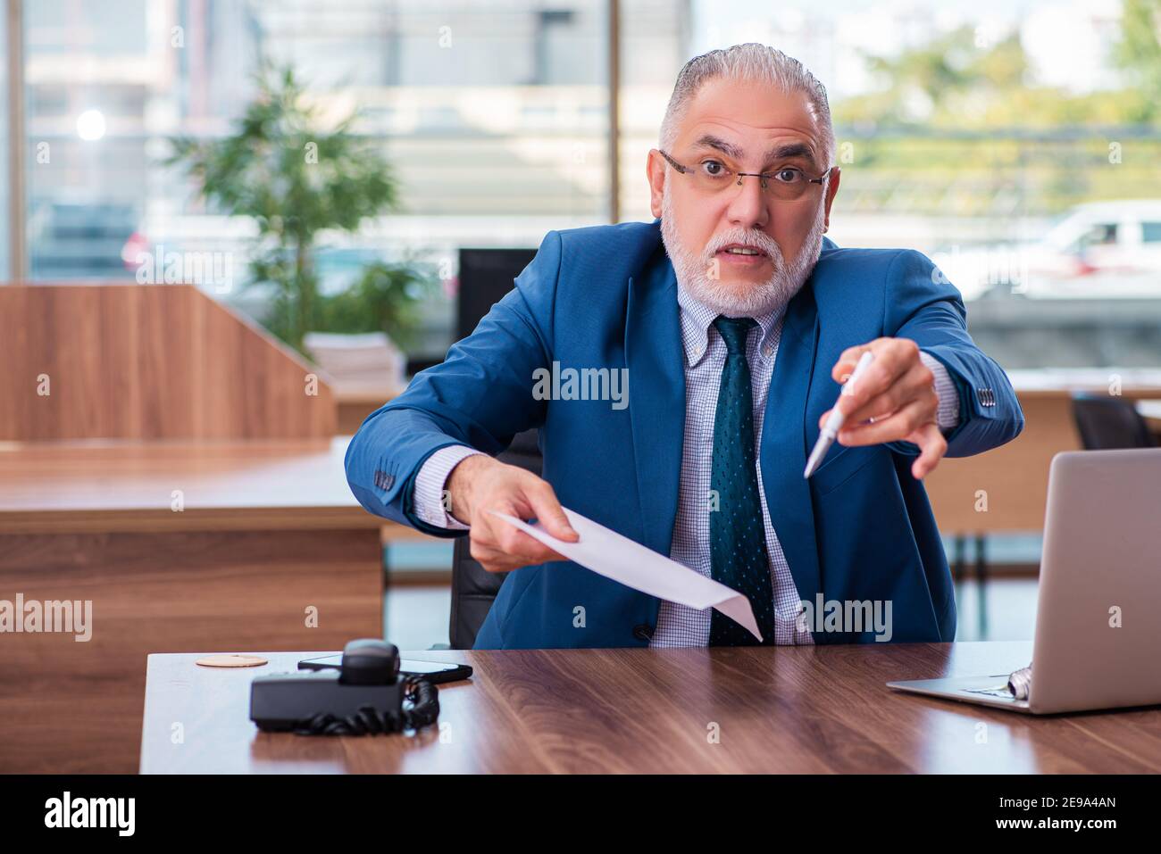 Old employee working in the office Stock Photo - Alamy