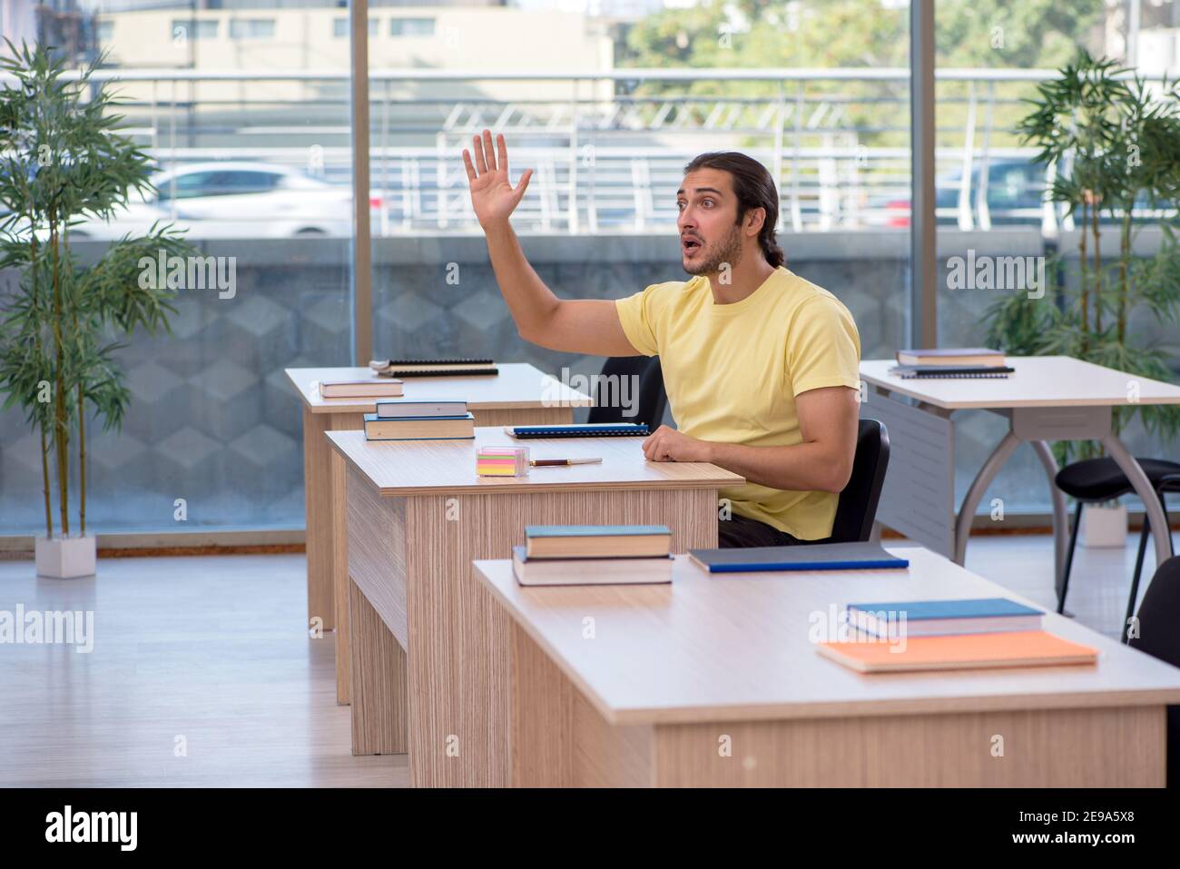 Male student sitting in the classroom Stock Photo - Alamy