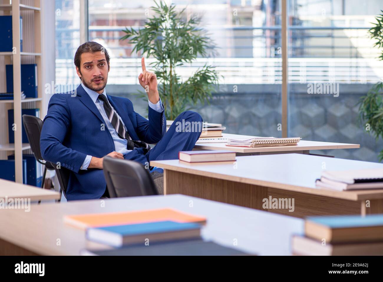Young teacher in suit in the classroom Stock Photo - Alamy