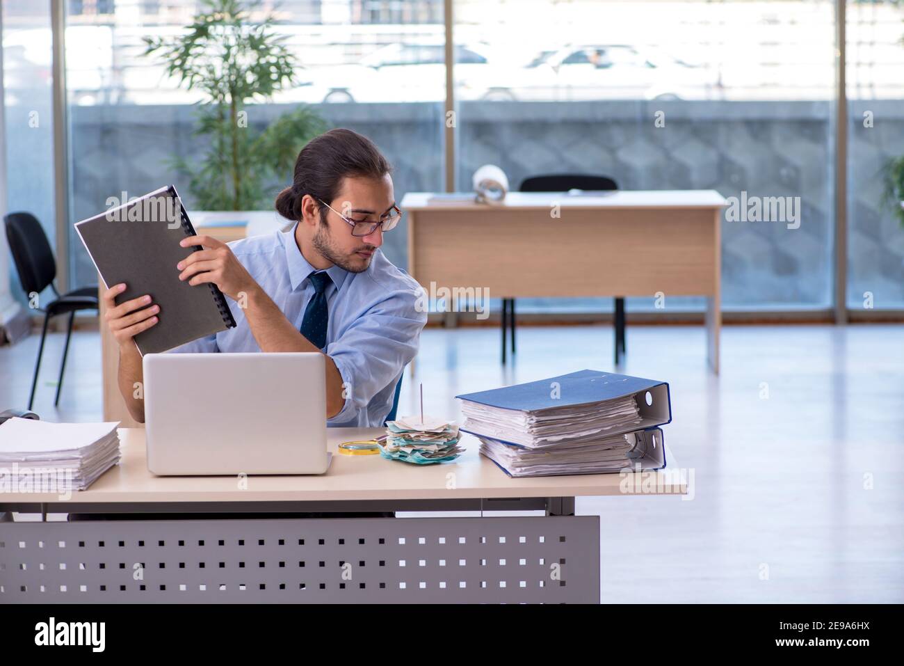 Young accountant working in the office Stock Photo - Alamy