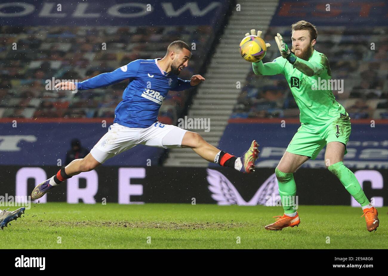 St Johnstone goalkeeper Zander Clark saves from Rangers' Kemar Roofe ...