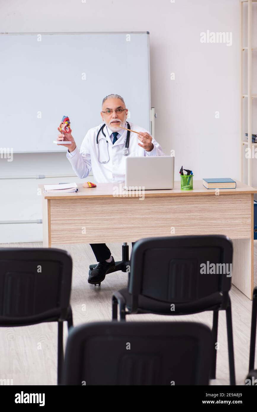 Old doctor lecturer in the classroom during pandemic Stock Photo - Alamy