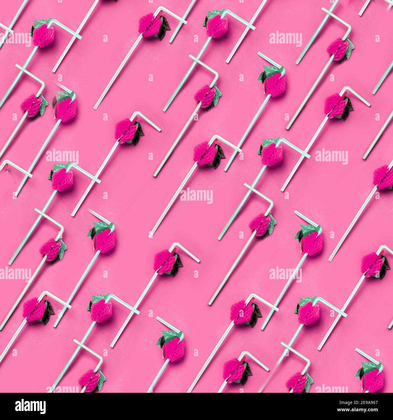 a pattern of straws with pink lemon-shaped head on pink background ...
