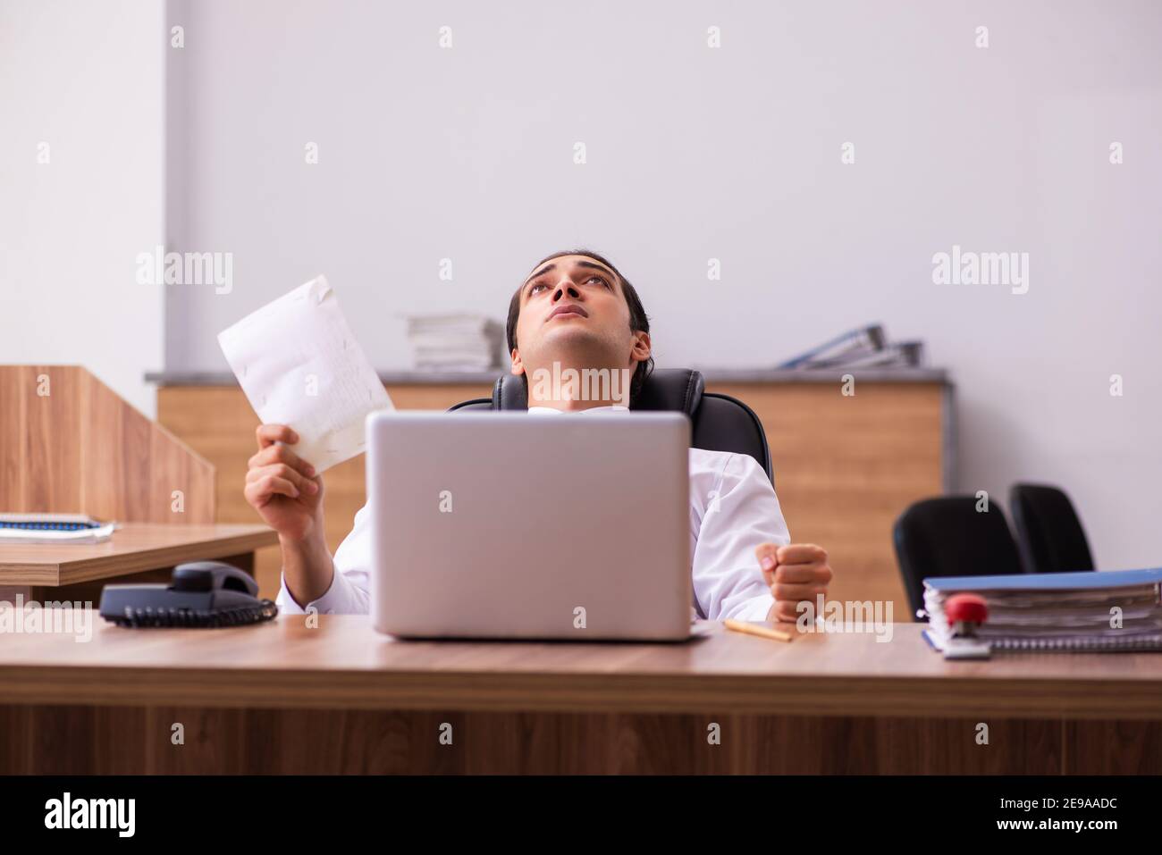 Young businessman employee unhappy with office prank in the office ...