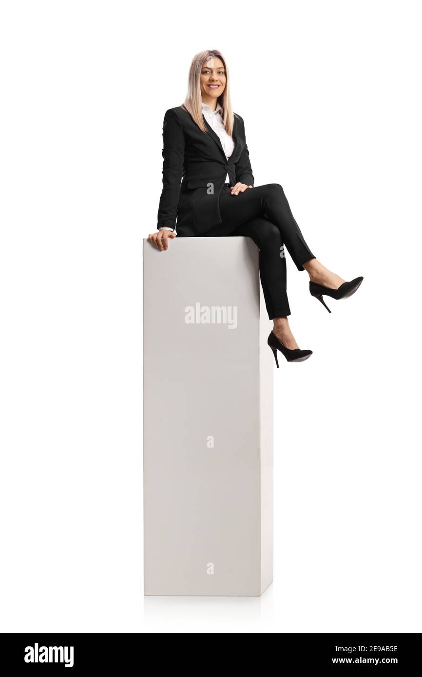 Young professional sitting on a white column isolated on white ...
