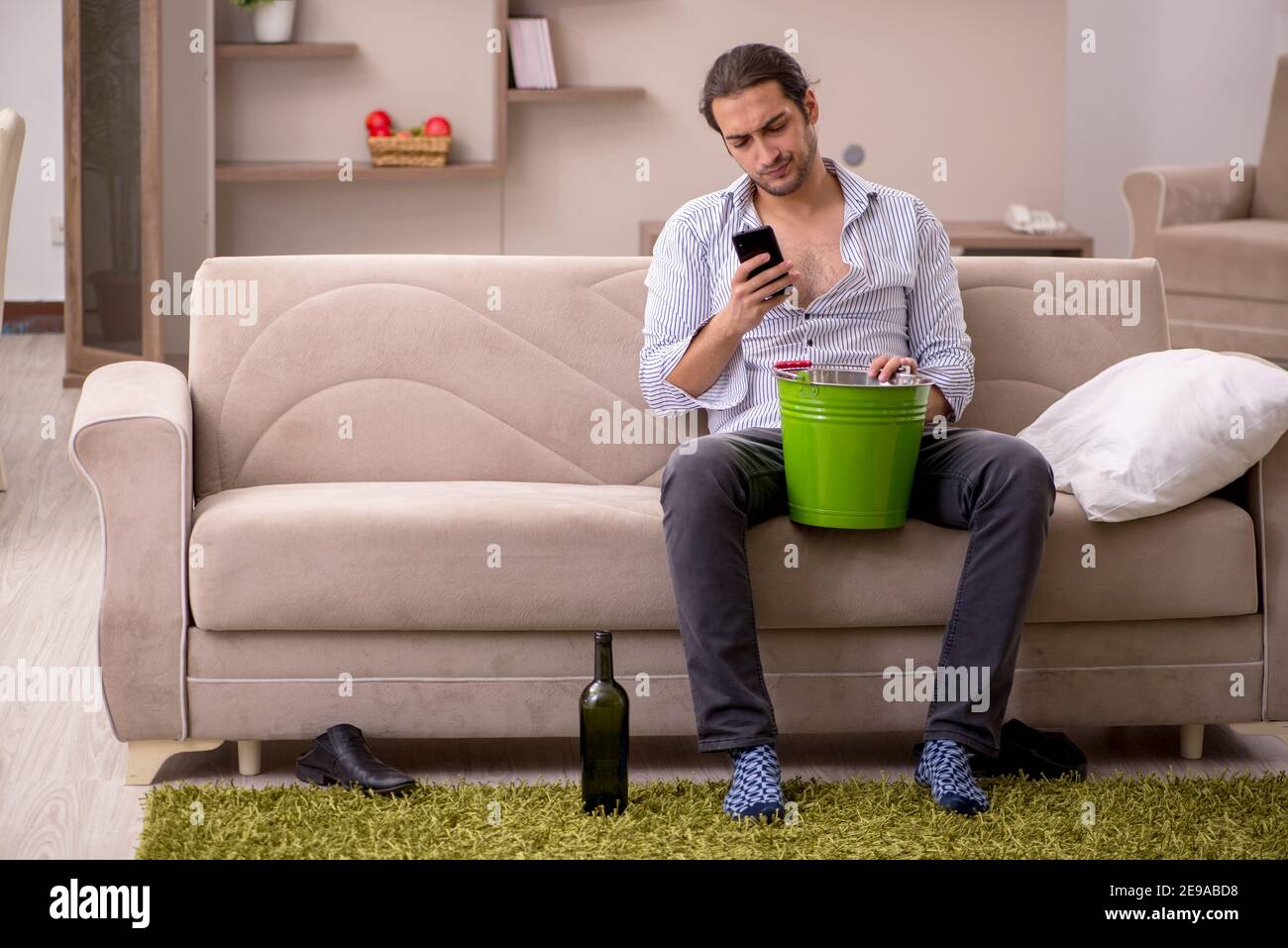Young drunken man suffering at home Stock Photo - Alamy